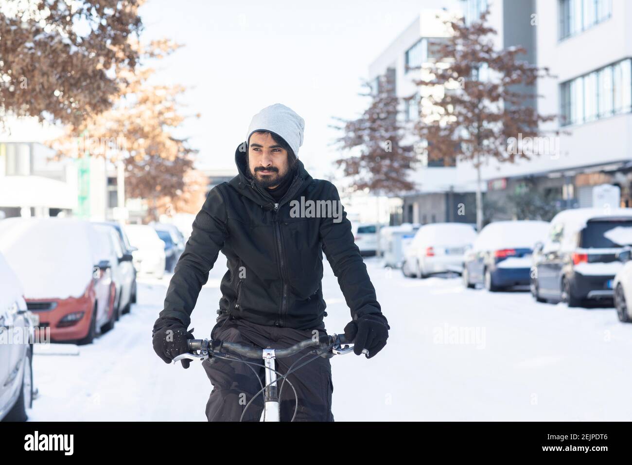Man riding bicycle in snow hi-res stock photography and images - Alamy