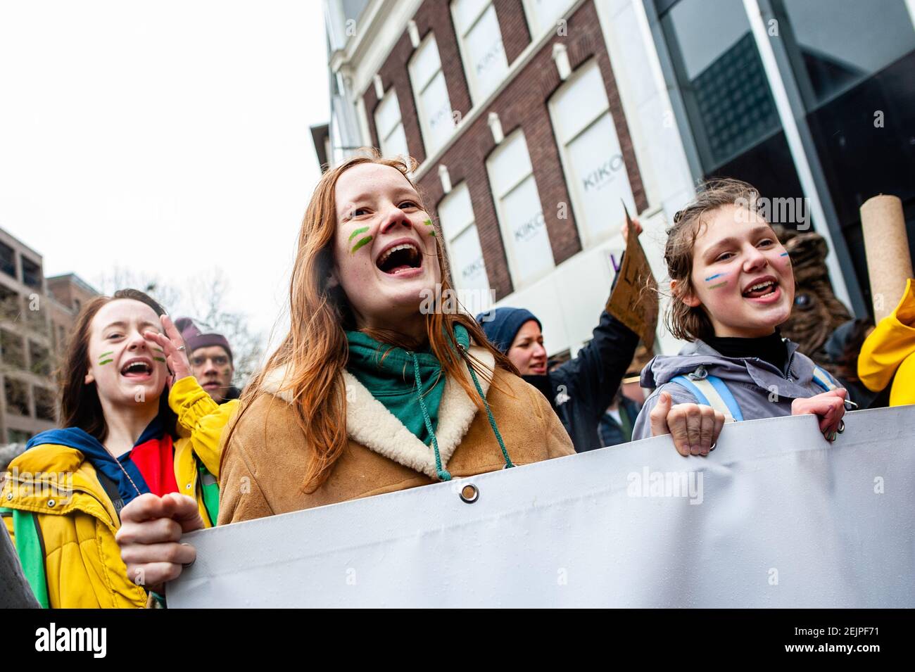 Three women shouting climate slogans during the demonstration. Under ...
