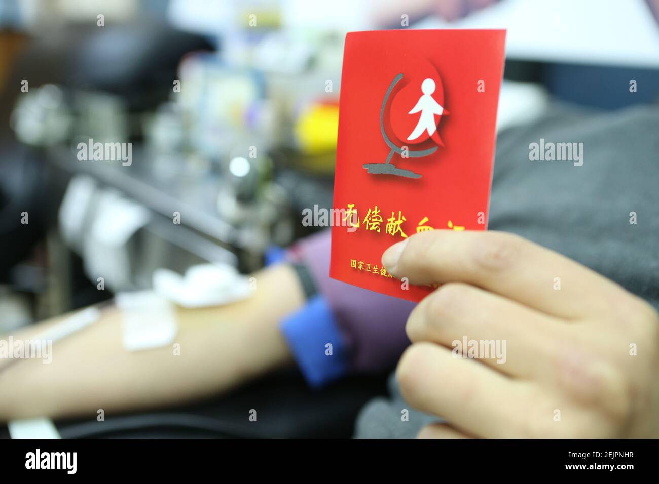 A donator gives out blood for saving lives at a bloodmobile, Shanghai ...