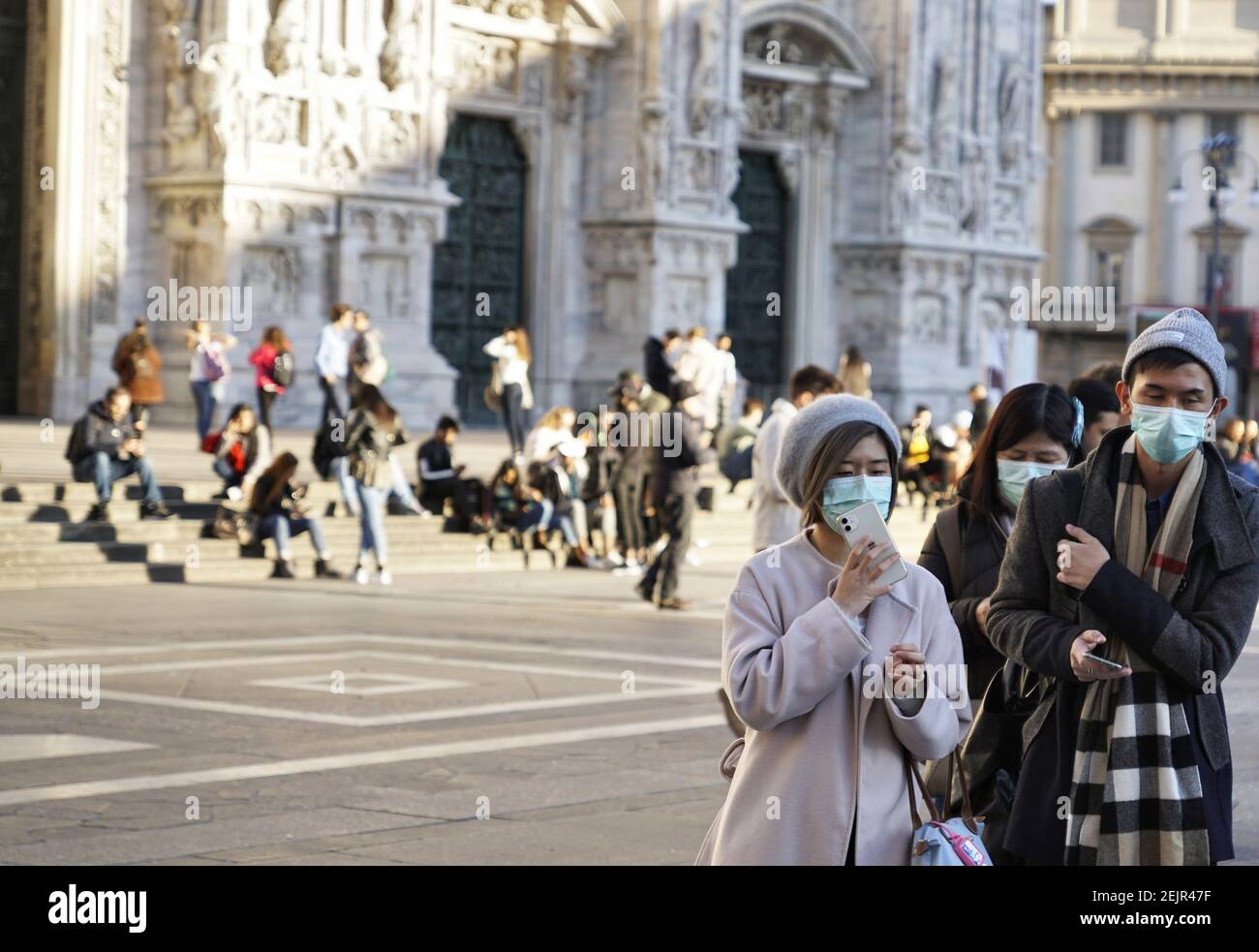 Coronavirus in Italy. Genre photo. Tourists in medical masks are seen ...