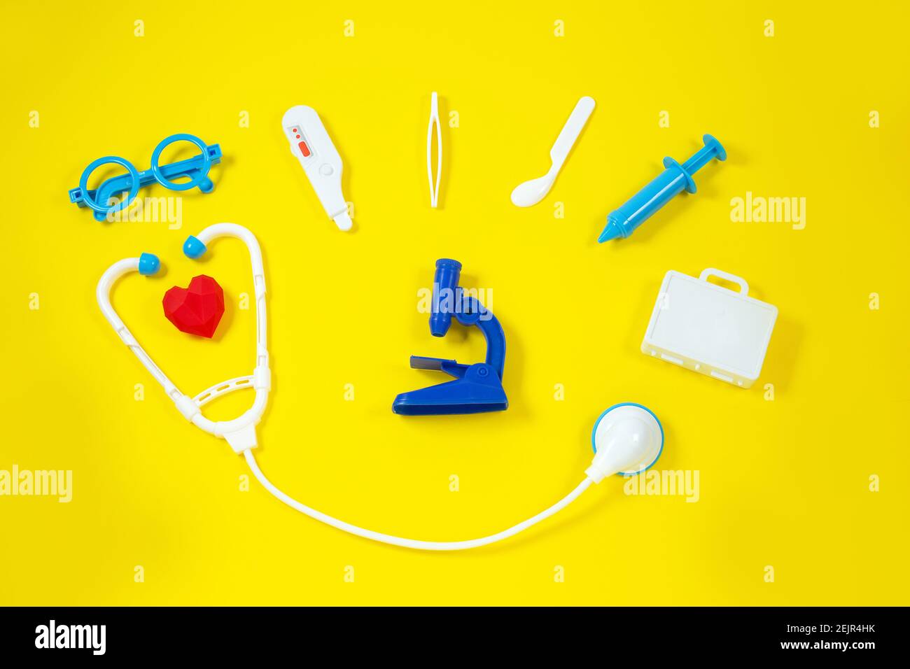Toy medical devices on a yellow background. Kids medical instruments ...