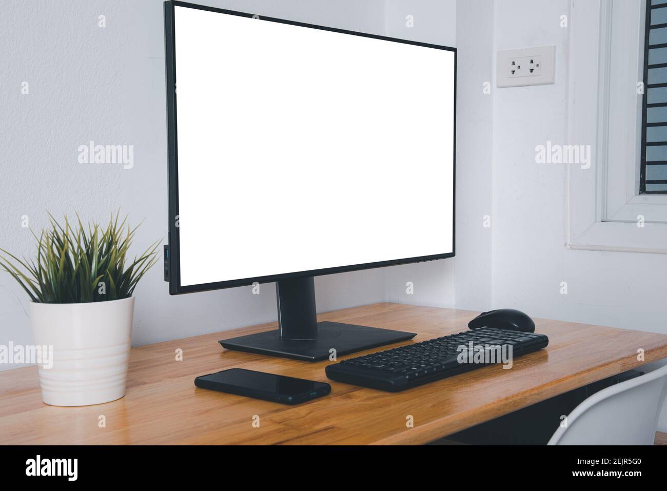 Computer monitor with white blank screen on the business desk with ...
