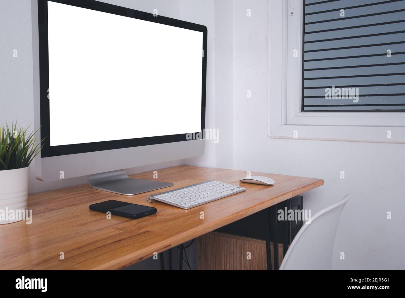 Computer monitor with white blank screen on the business desk with ...