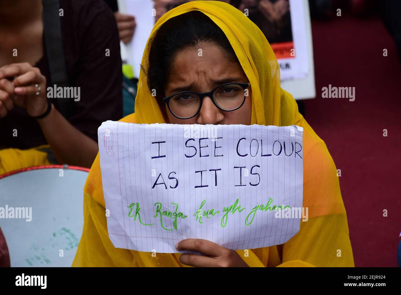 An Indian activist holds a placard during the protest against the ...
