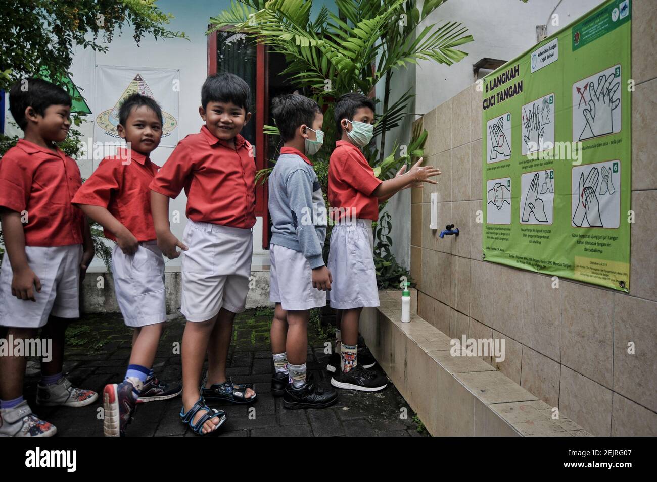Kindergarten students attend a hand washing training session using soap ...