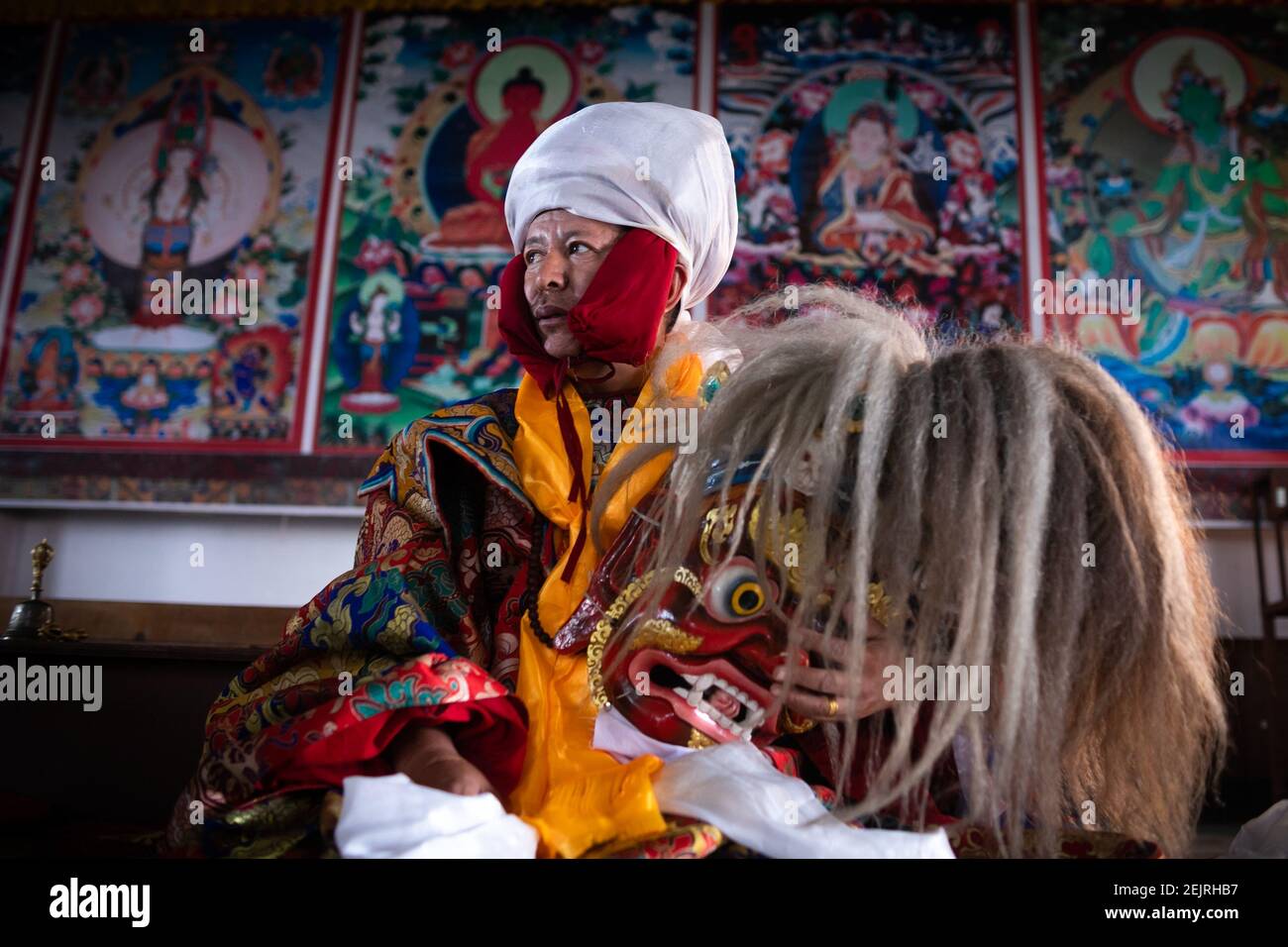 A masked dancer before the traditional Cham dance performance during ...
