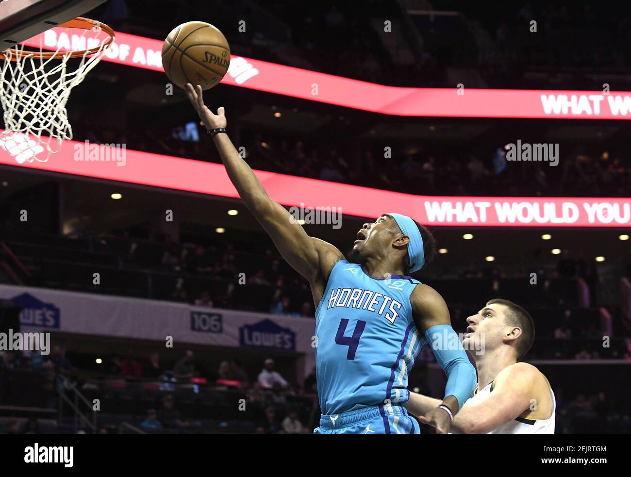 The Charlotte Hornets' Devonte' Graham (4) drives past the Denver ...
