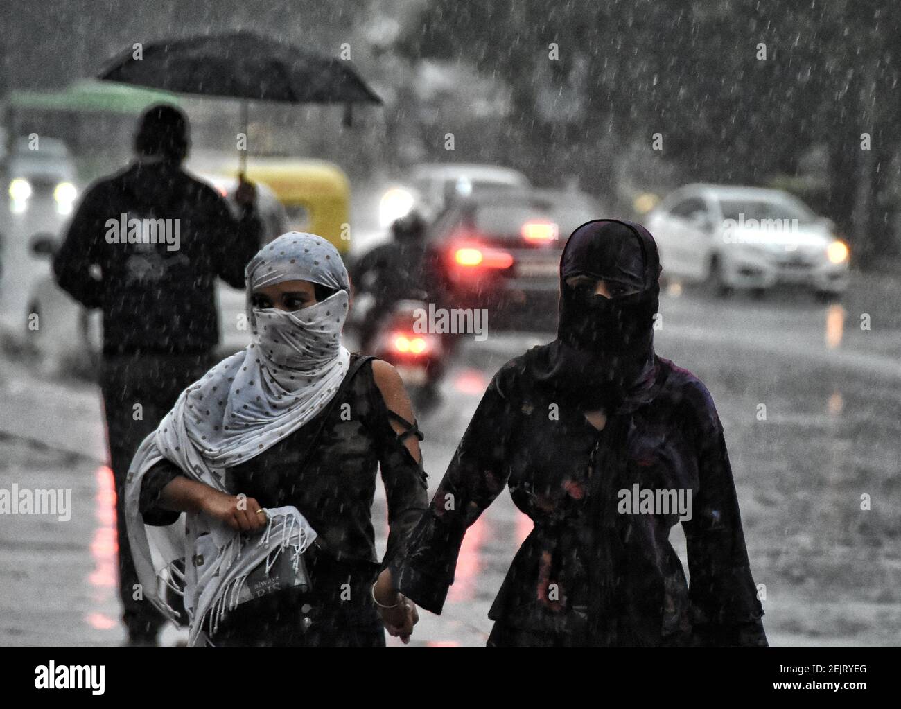 People drenched in the rain walking in Rajpth during a heavy monsoon ...