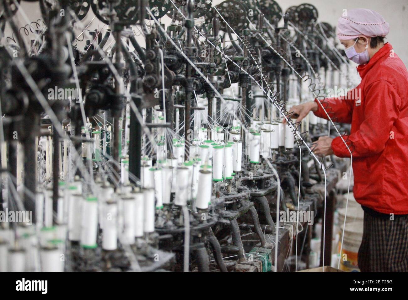 A Chinese worker labors at a textile factory in Yanshanhe Village ...