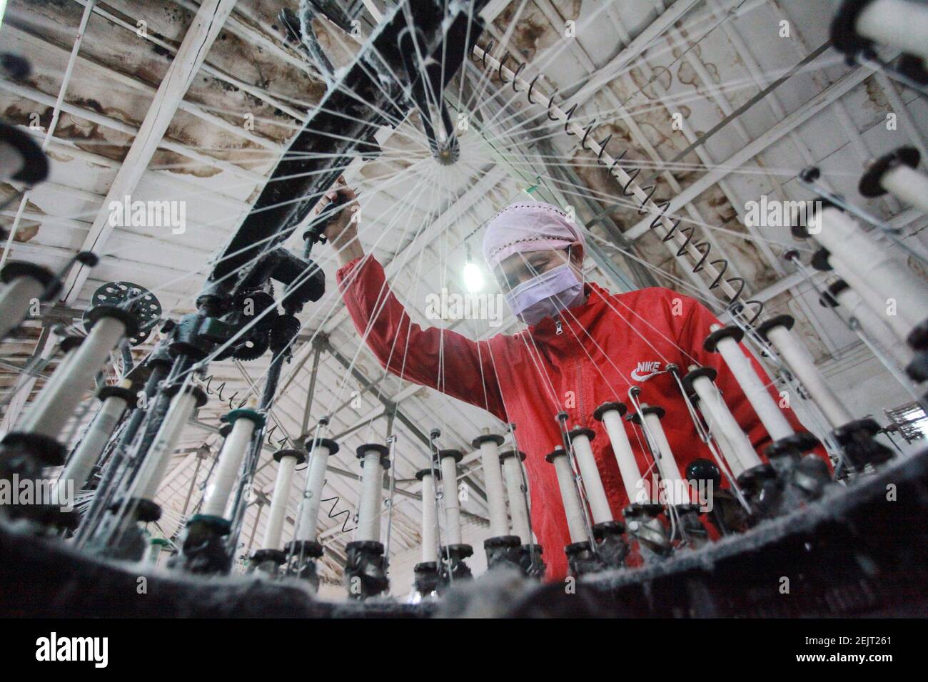 A Chinese worker labors at a textile factory in Yanshanhe Village ...