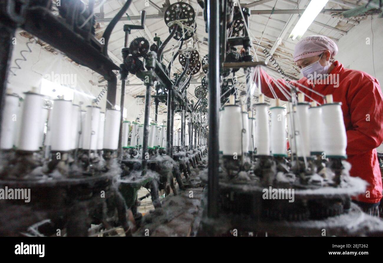 A Chinese worker labors at a textile factory in Yanshanhe Village ...