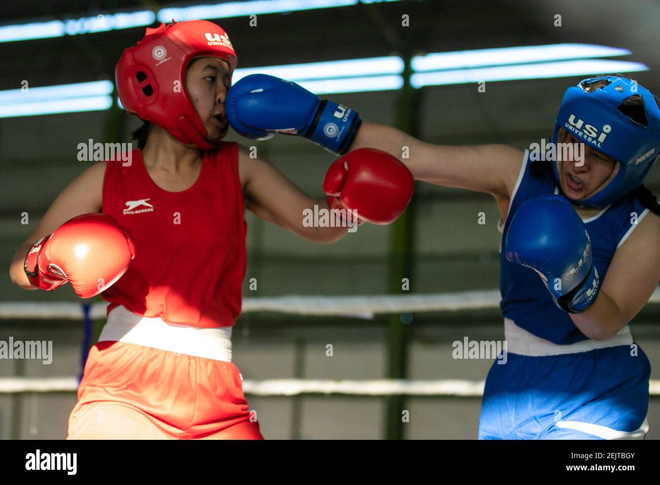 Nepalese woman boxer in blue jersey, Roshani Rai punches Sumina Khadka ...