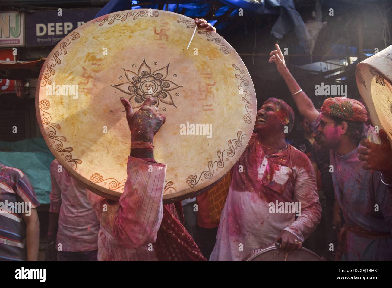 Hindu devotees playing a drum during the festival. Holi is a popular ...