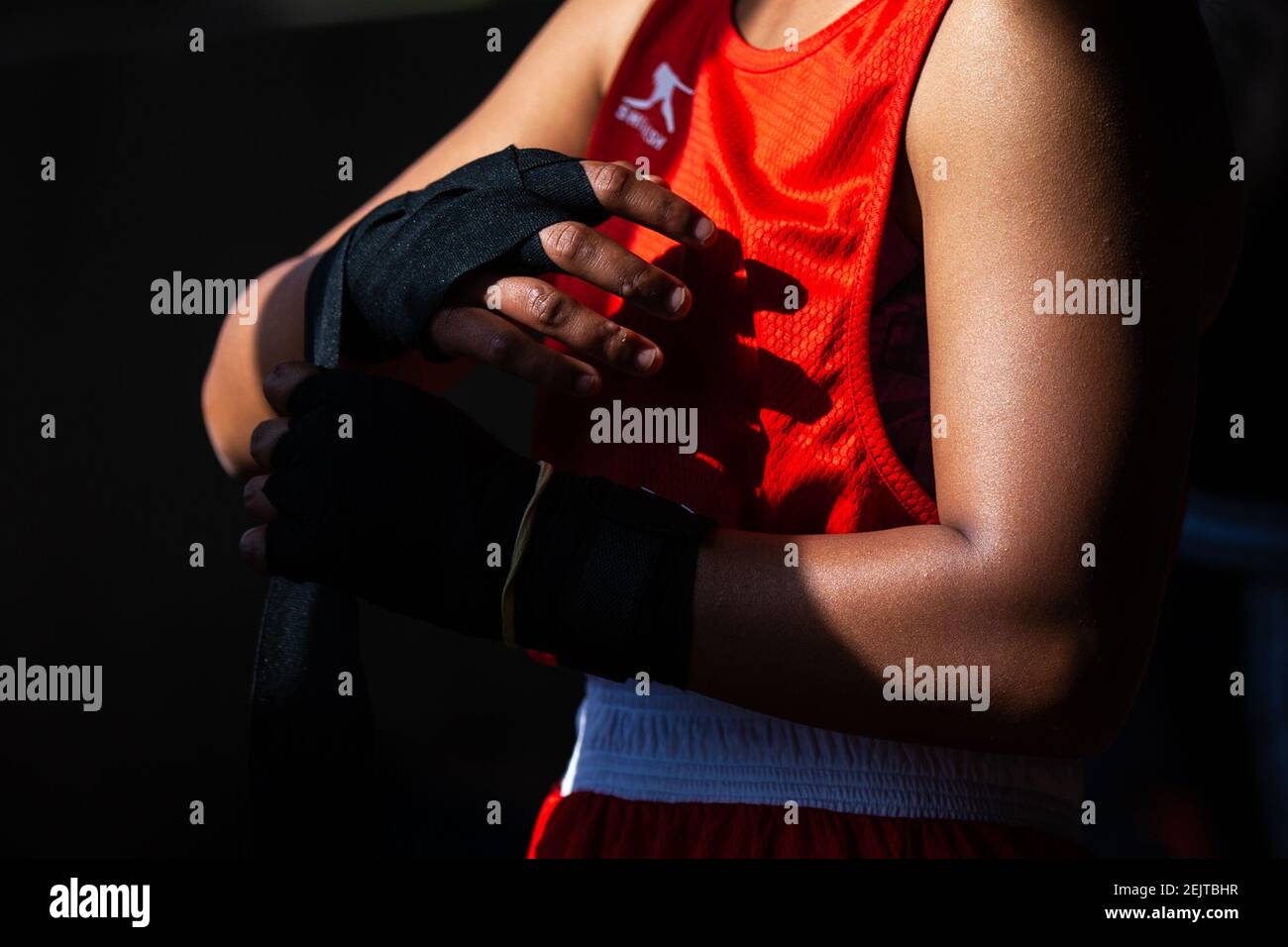 A Nepalese woman boxer gets ready for her bout during a boxing match ...