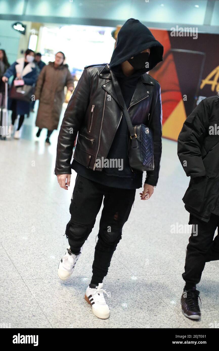 Chinese actor and singer Tan Jianci arrives at a Beijing airport after ...