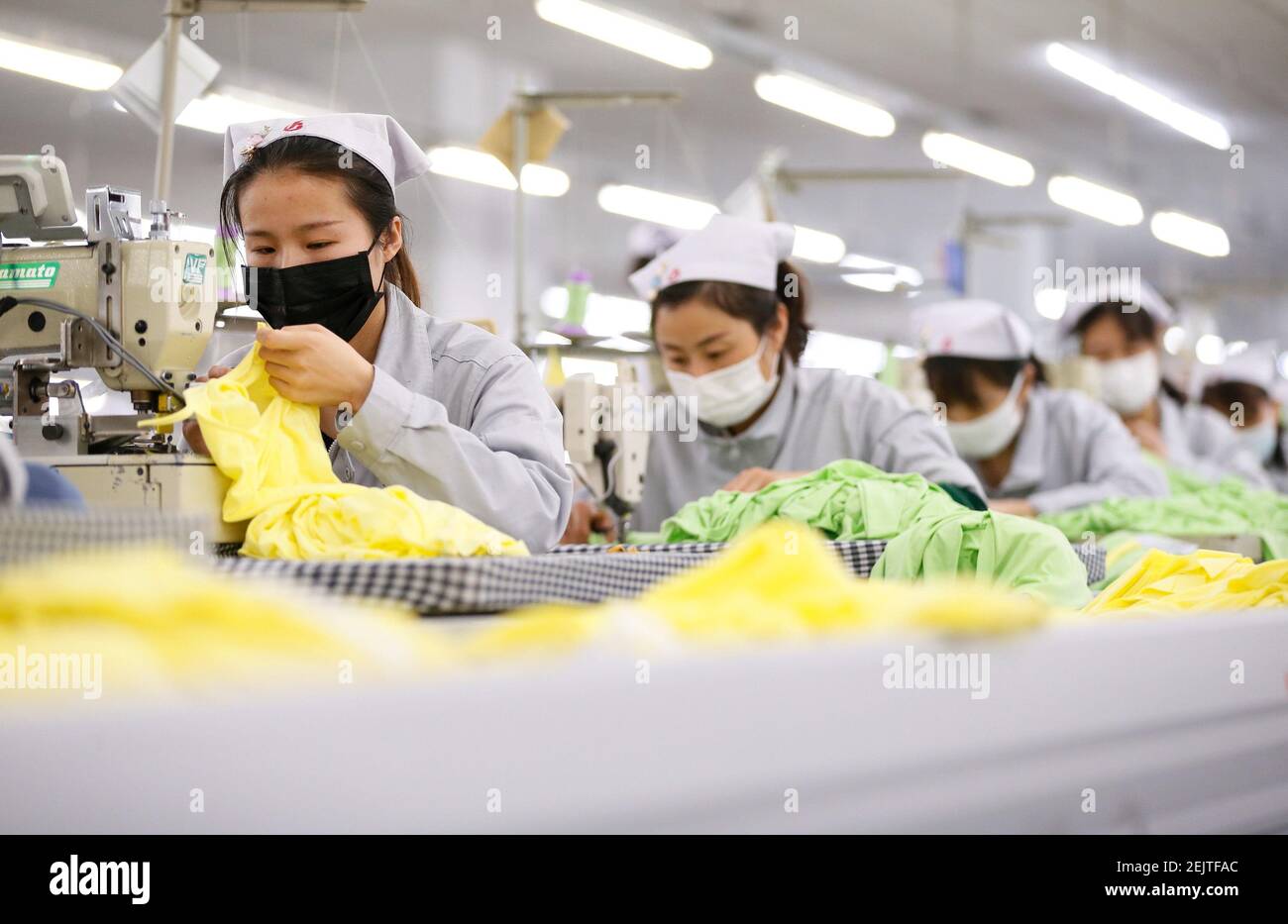 Staff at a local spinning mill work to produce n to meet the demand of ...