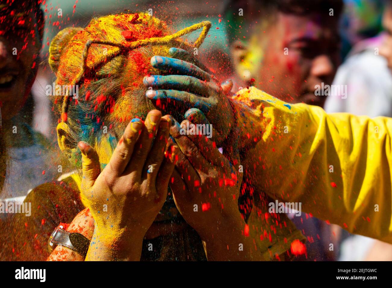 A kid covered with Vermilion powder during the festival. Holi festival ...