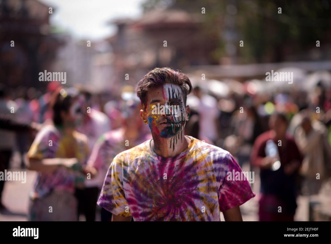 A man's face covered with Vermilion powder during the festival. Holi ...