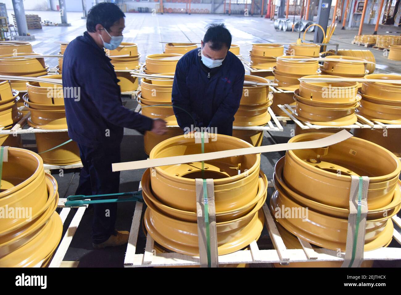 Staff work to produce wheel hubs at a local steal factory to meet the ...