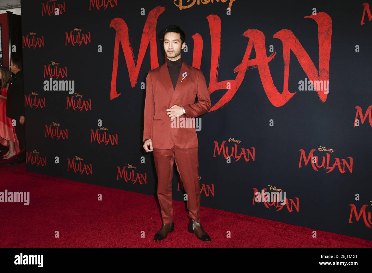 Yoson An walking the red carpet at Premiere Of Disney's "Mulan" held at ...