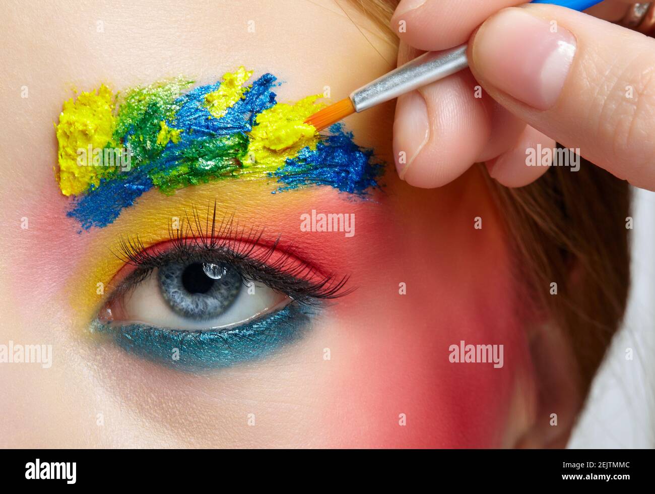 Female portrait with unusual face art makeup. Paint on brows. Artist's ...