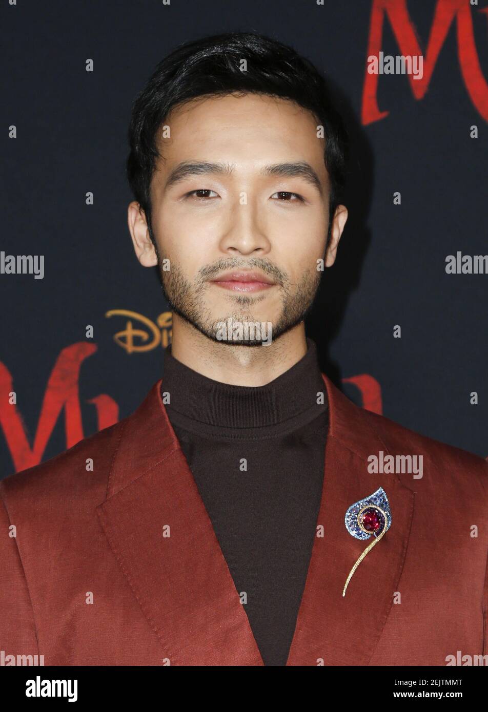 Yoson An walking the red carpet at Premiere Of Disney's "Mulan" held at ...