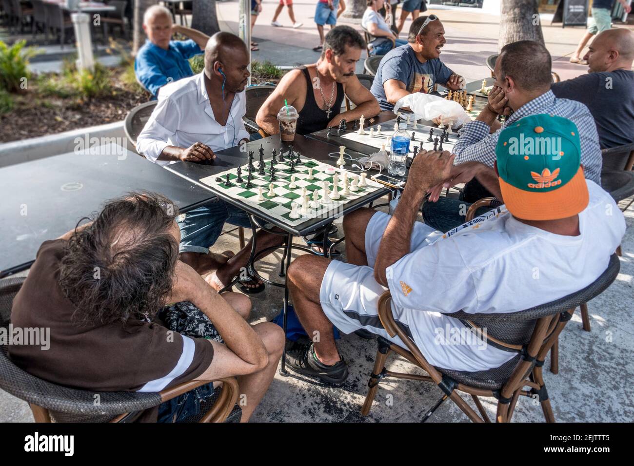 A group of men playing chess on the Lincoln Road Mall in Miami Beach ...