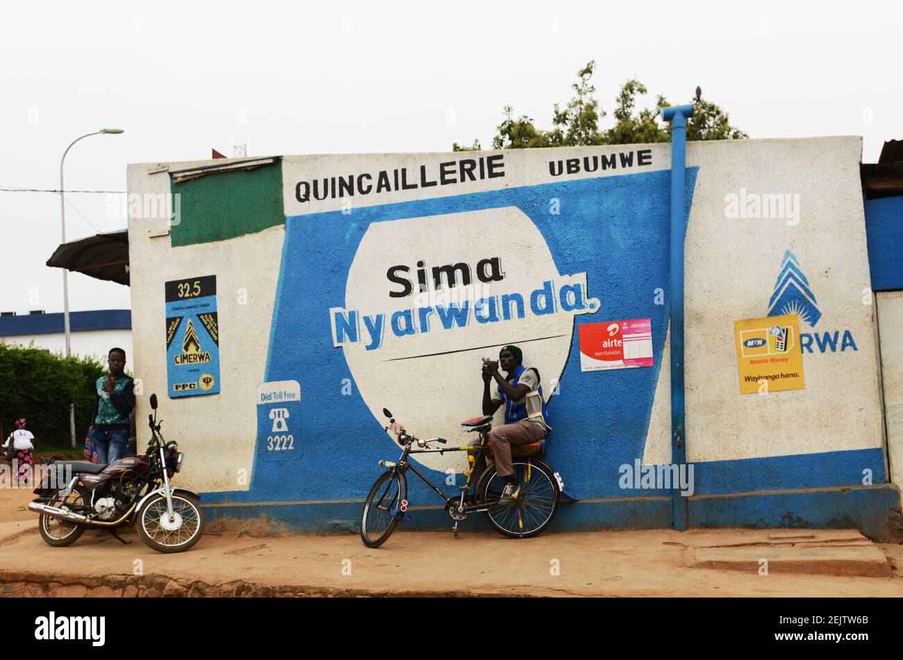 A Rwandan cycle taxi driver standing by his bicycle in Kigali, Rwanda ...
