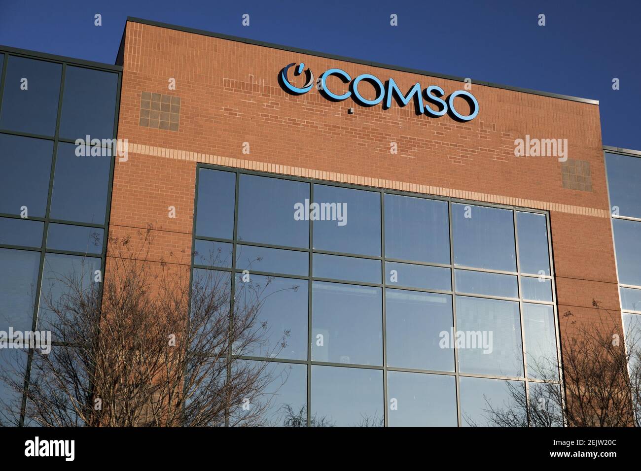 A logo sign outside of a facility occupied by Comso in Columbia ...