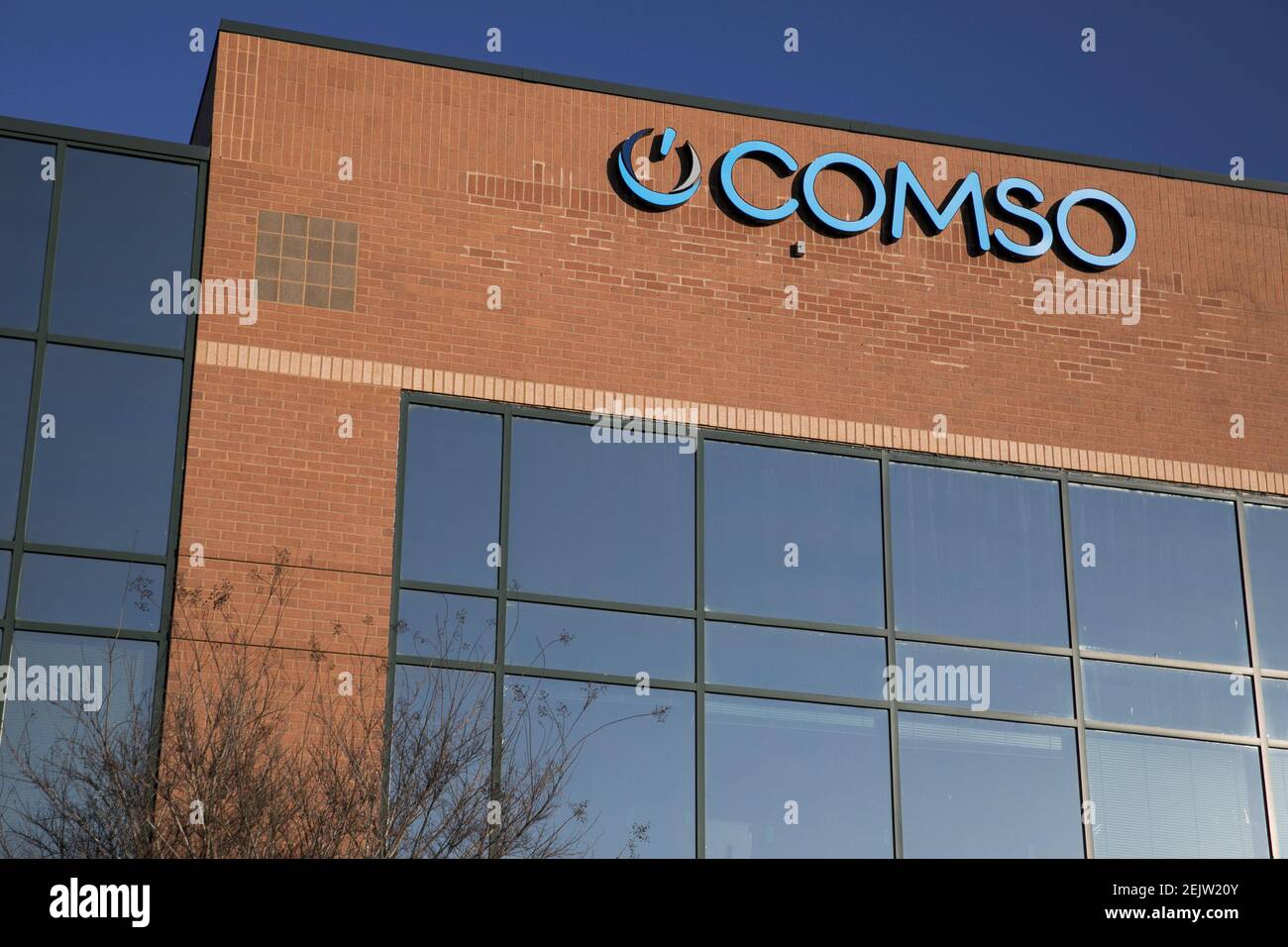 A logo sign outside of a facility occupied by Comso in Columbia ...