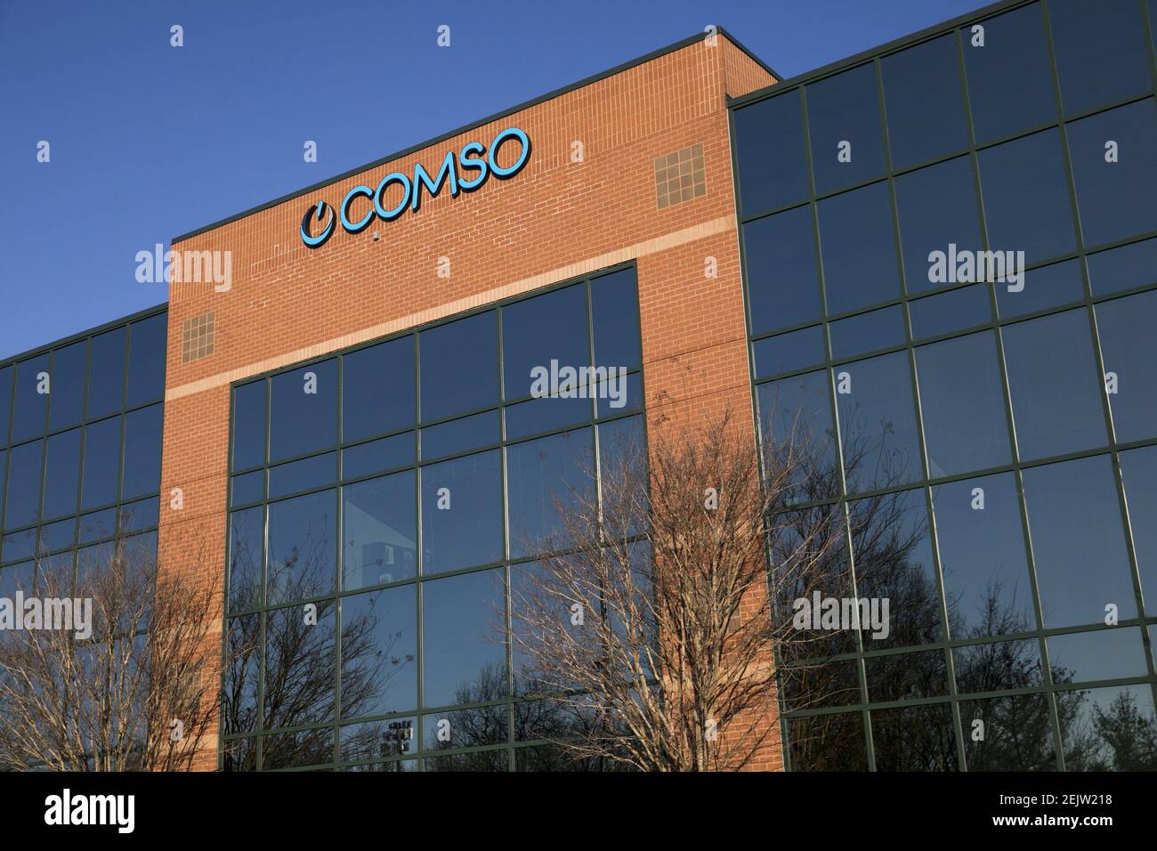 A logo sign outside of a facility occupied by Comso in Columbia ...
