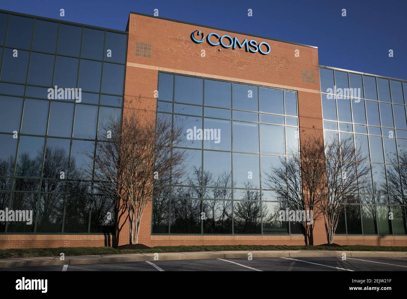 A logo sign outside of a facility occupied by Comso in Columbia ...