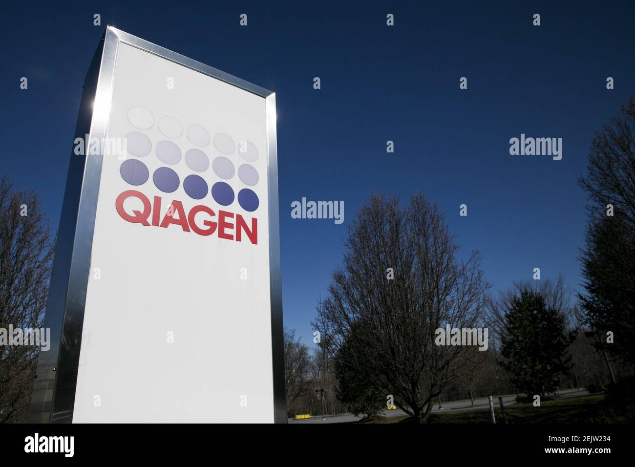A logo sign outside of a facility occupied by QIAGEN in Germantown ...