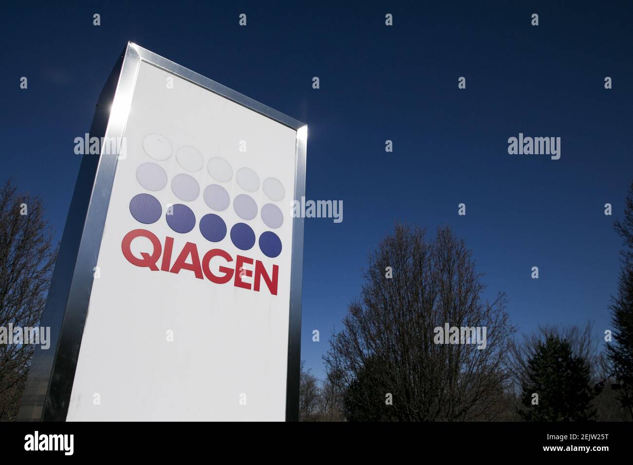 A logo sign outside of a facility occupied by QIAGEN in Germantown ...