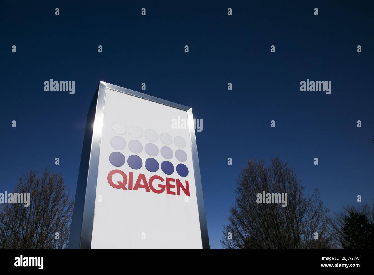 A logo sign outside of a facility occupied by QIAGEN in Germantown ...