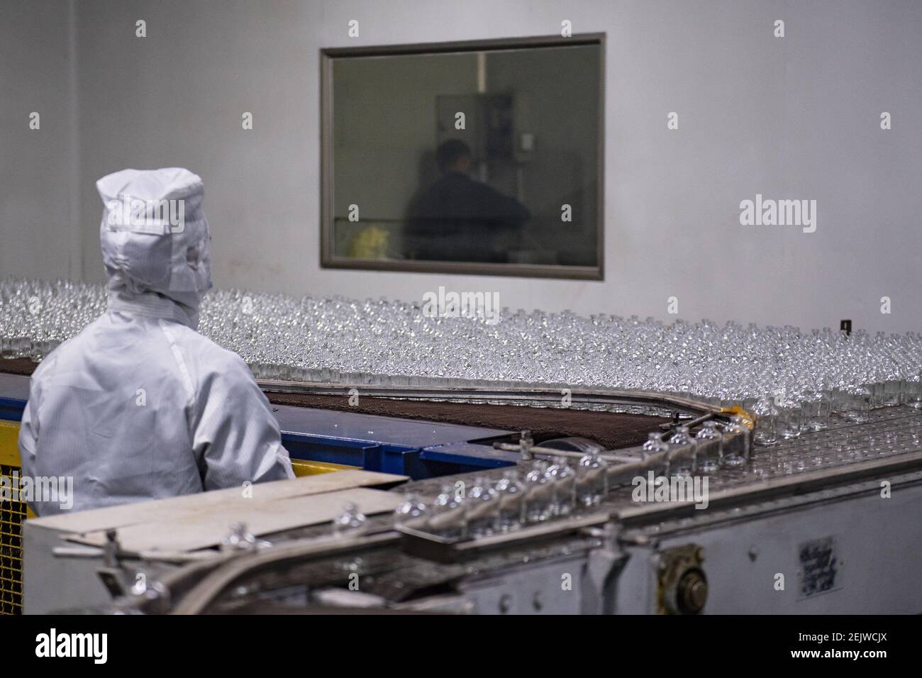 Staff of Guangming glass factory work along the automated production ...