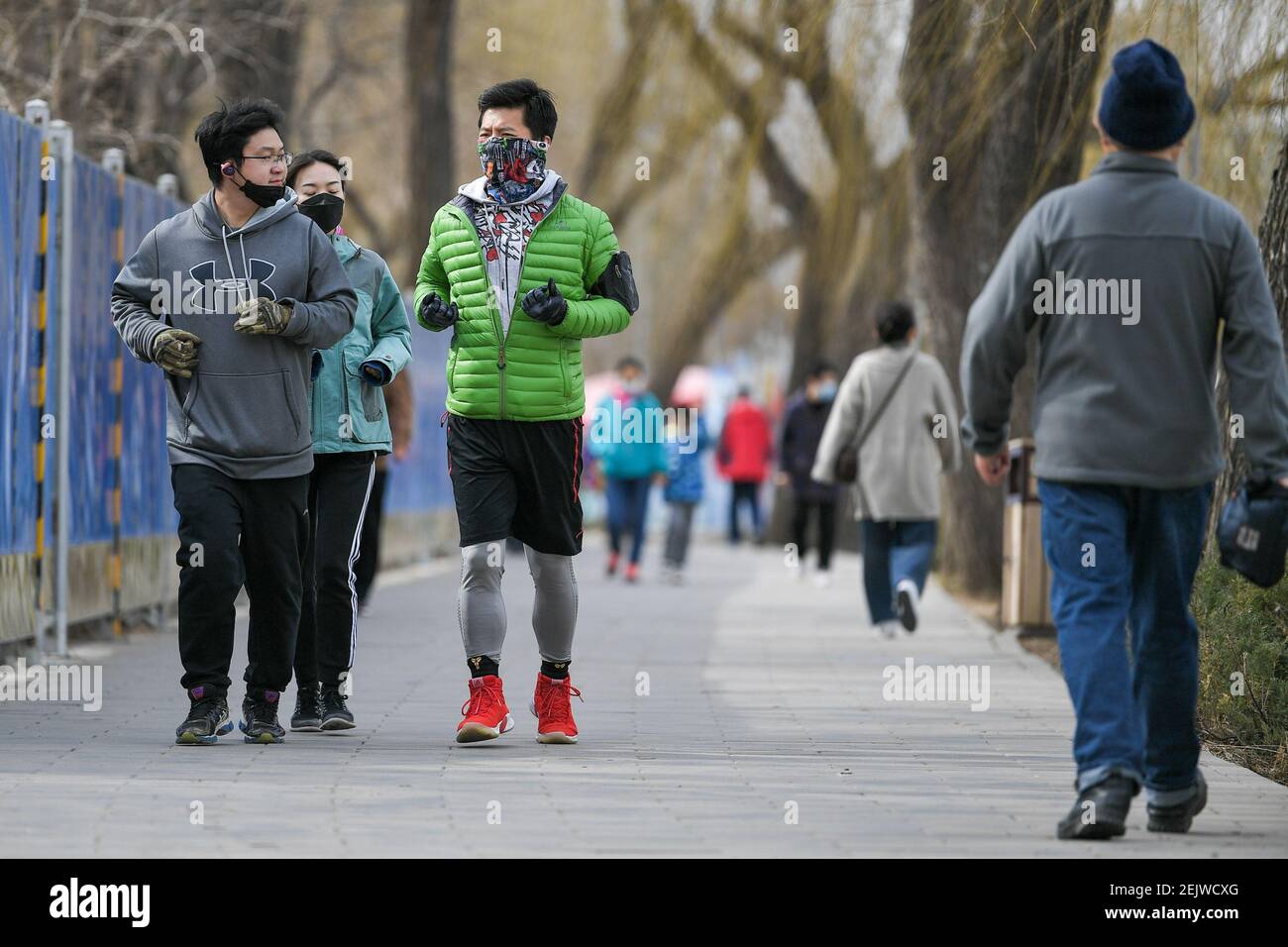 Citizens do exercise by jogging or with fitness equipment at a local ...