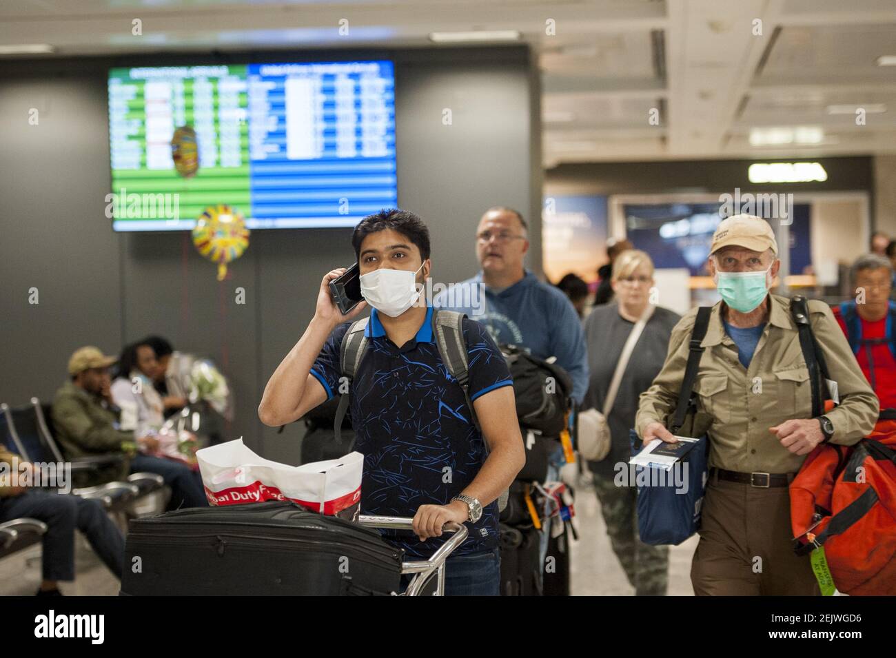 Passengers arrive from Dubai after a 14-hour flight on Emirates flight ...