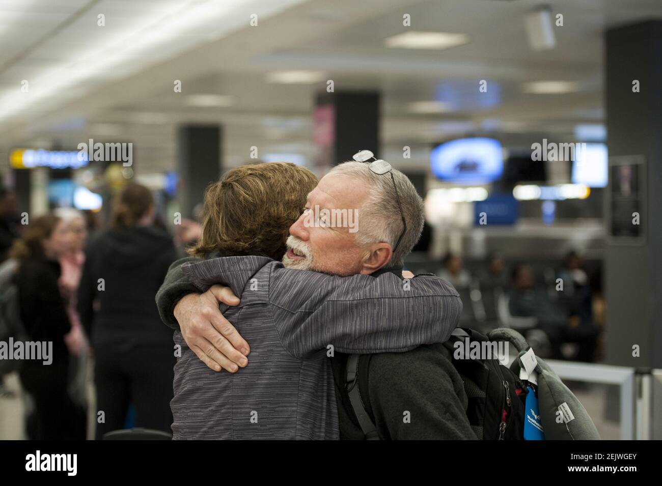 A man is embraced after arriving from Dubai on a 14-hour flight on ...
