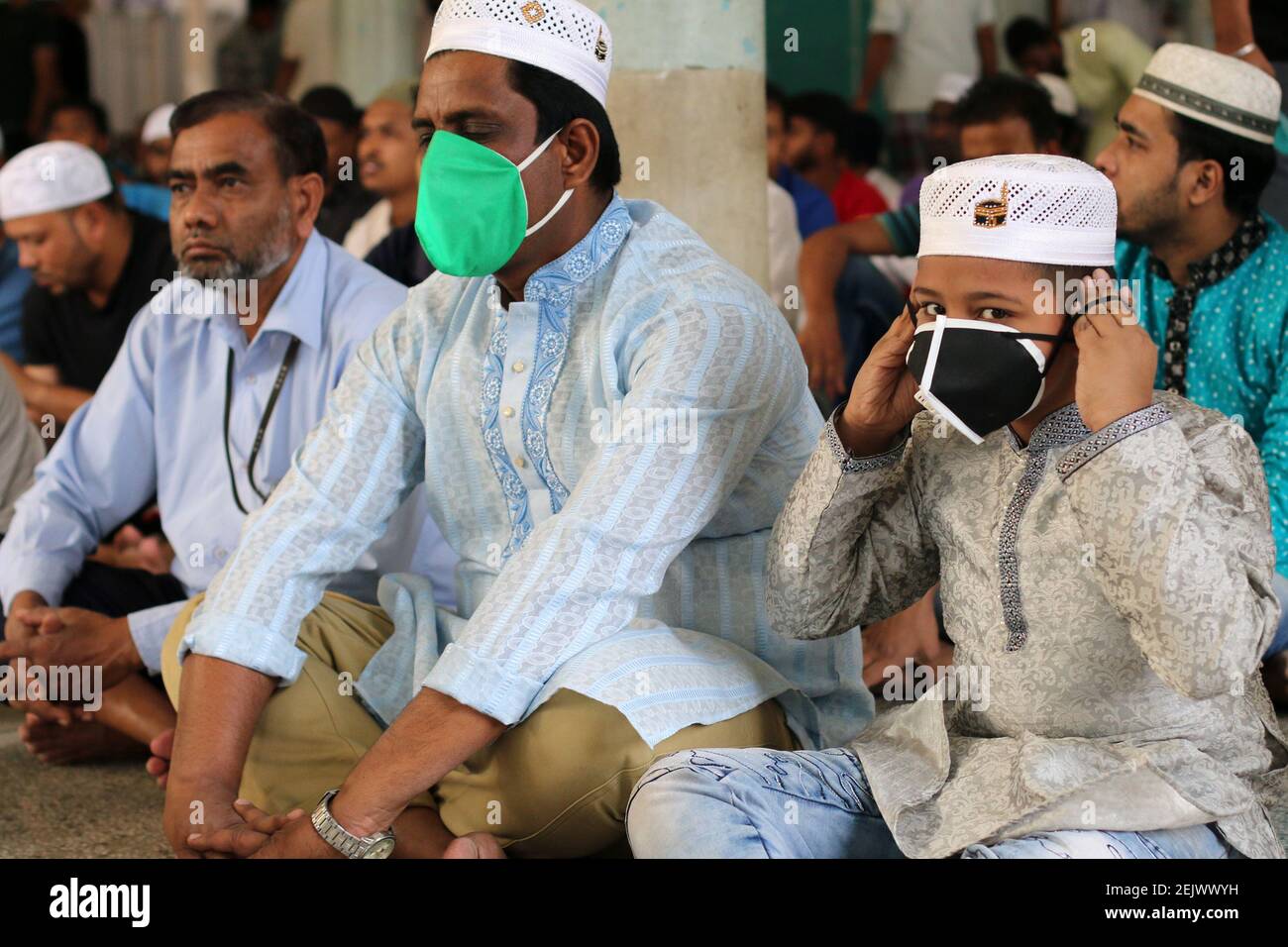 Muslims wear protective masks while offering Friday prayers (Jummah) as ...