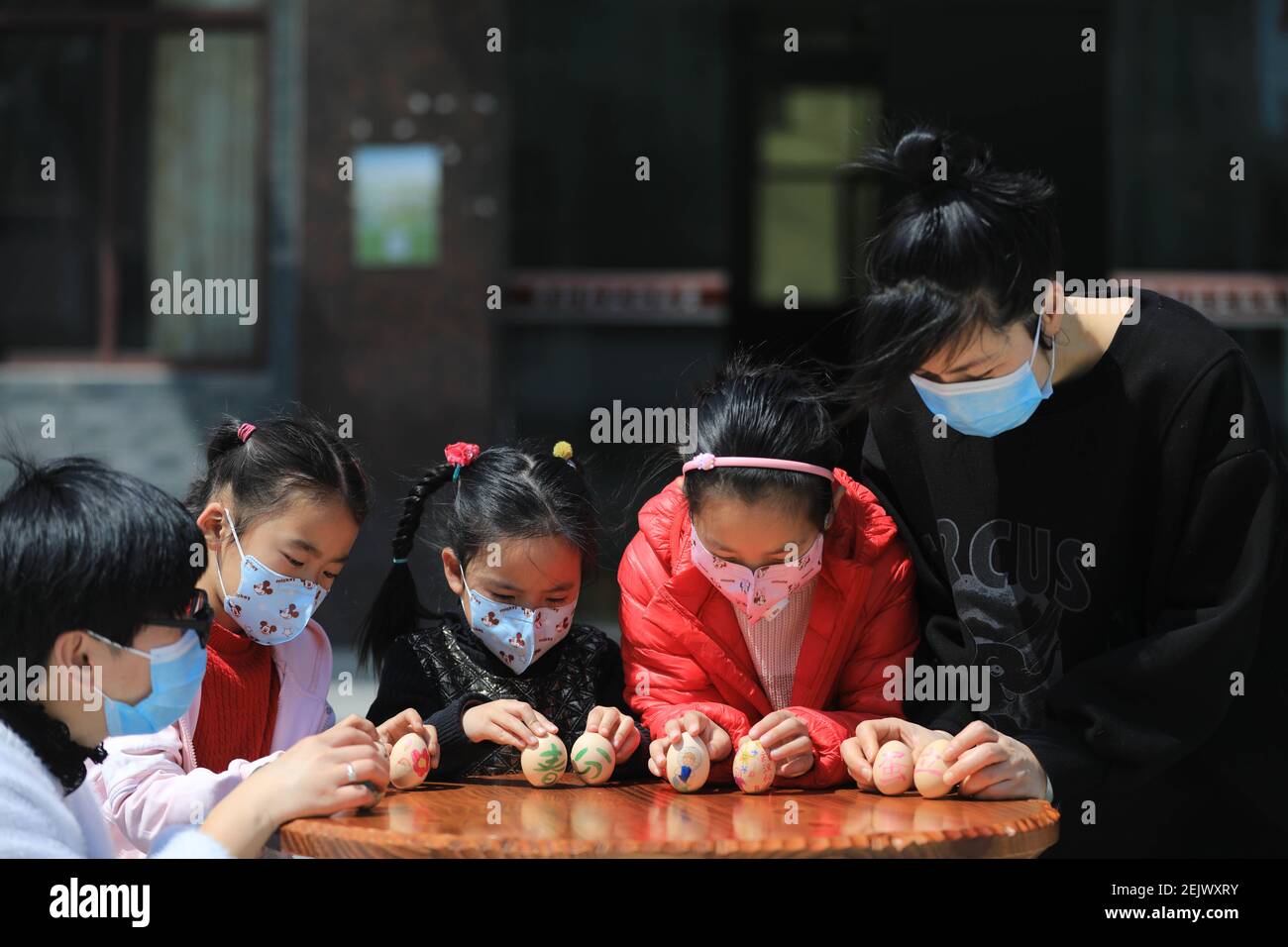 Childrens are playing egg standing game to welcome traditional festival ...