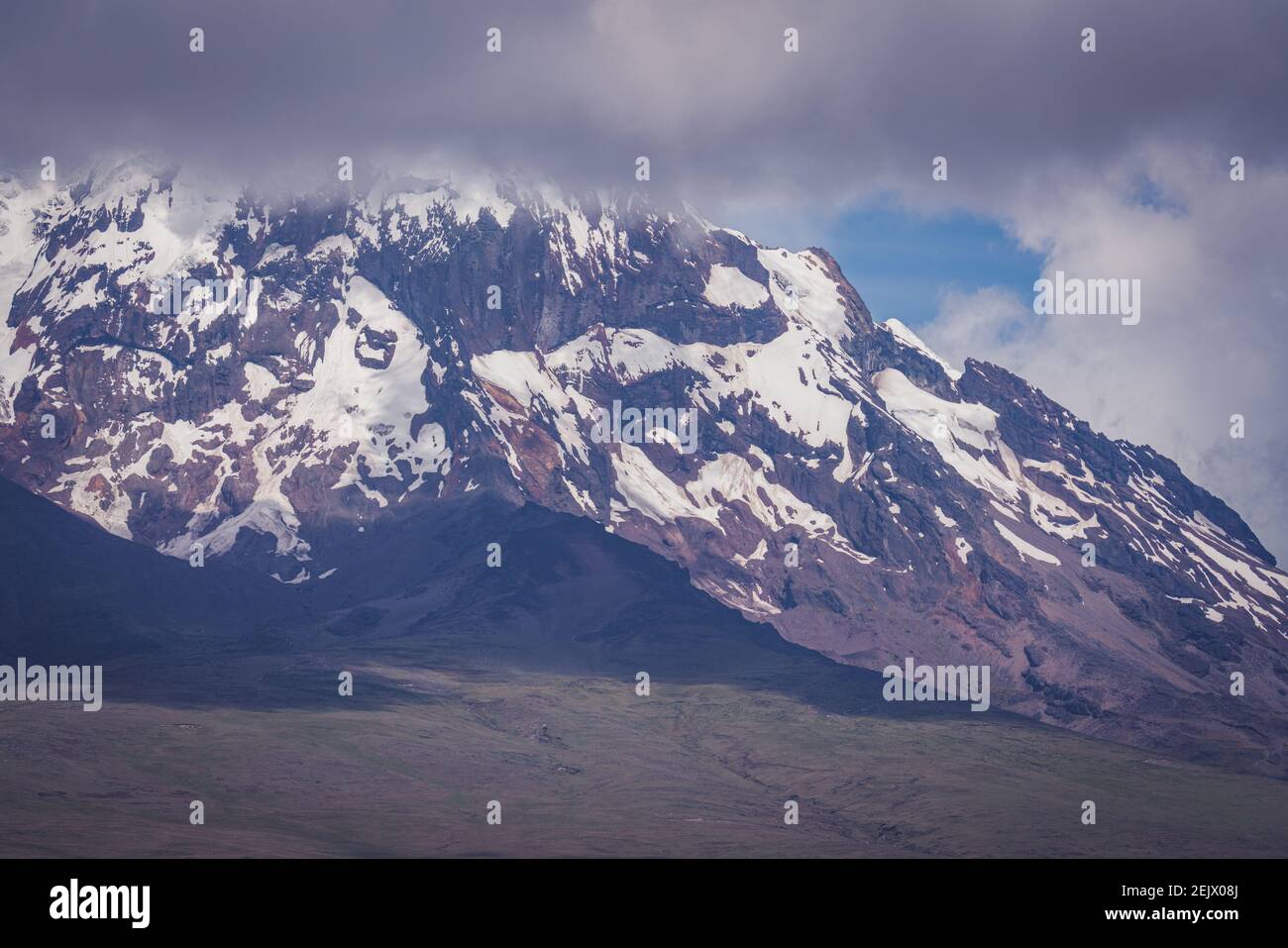 Beautiful scenery of snow on mountain ranges under a gloomy sky Stock Photo - Alamy