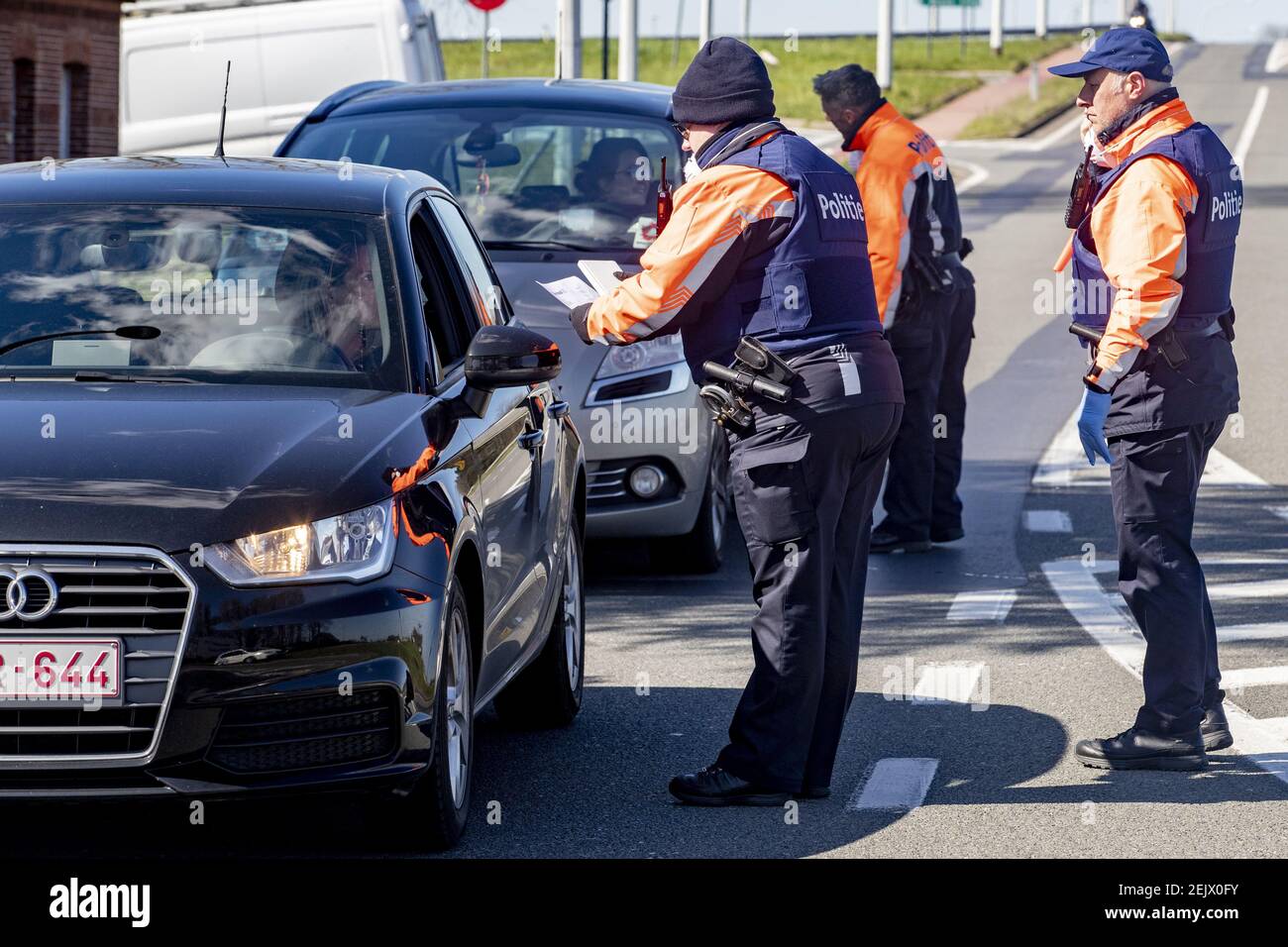 Border police officers inspecting vehicles at a check point. Bordering ...
