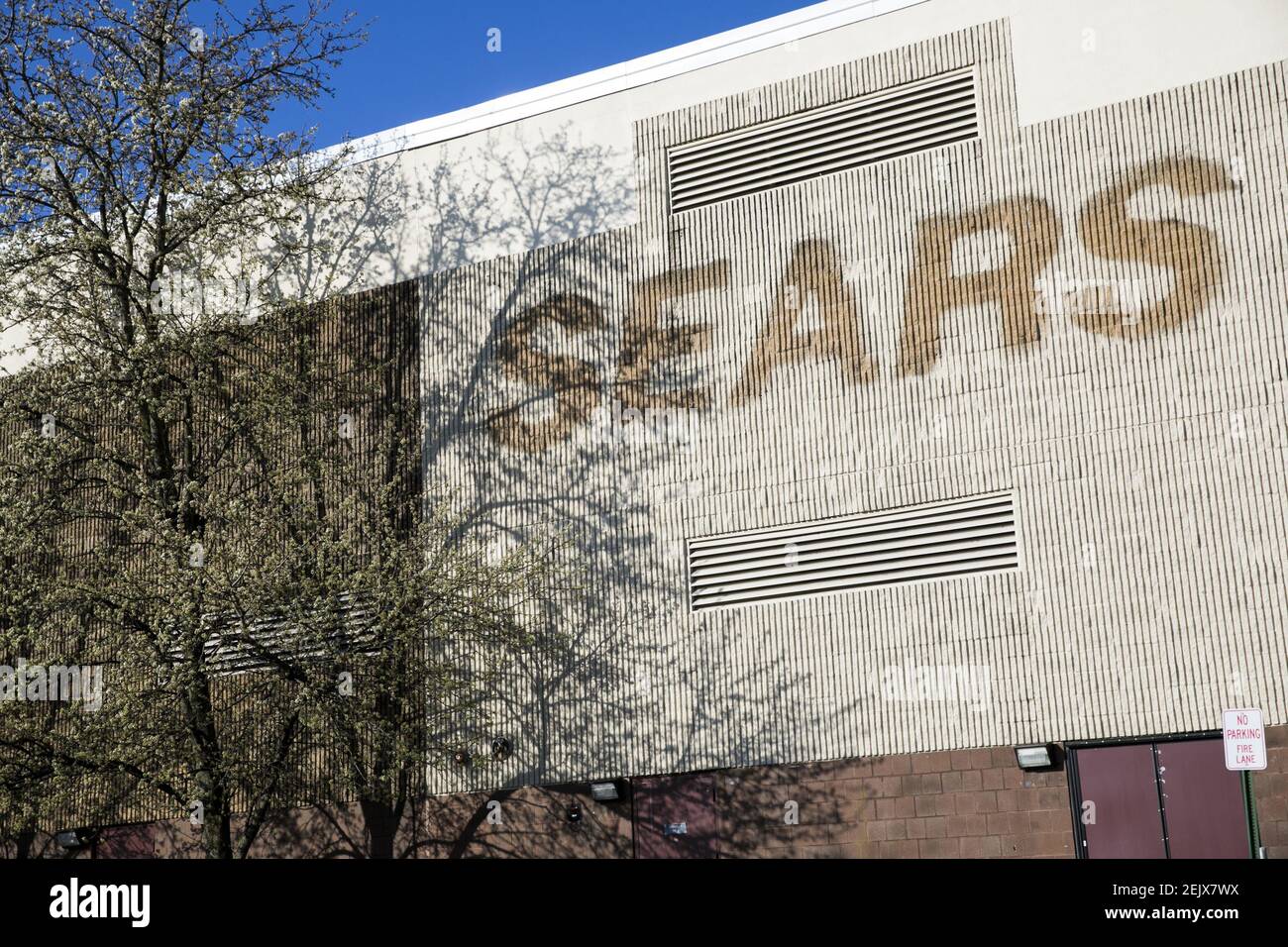 The faded outline of a Sears logo sign outside of a closed and ...