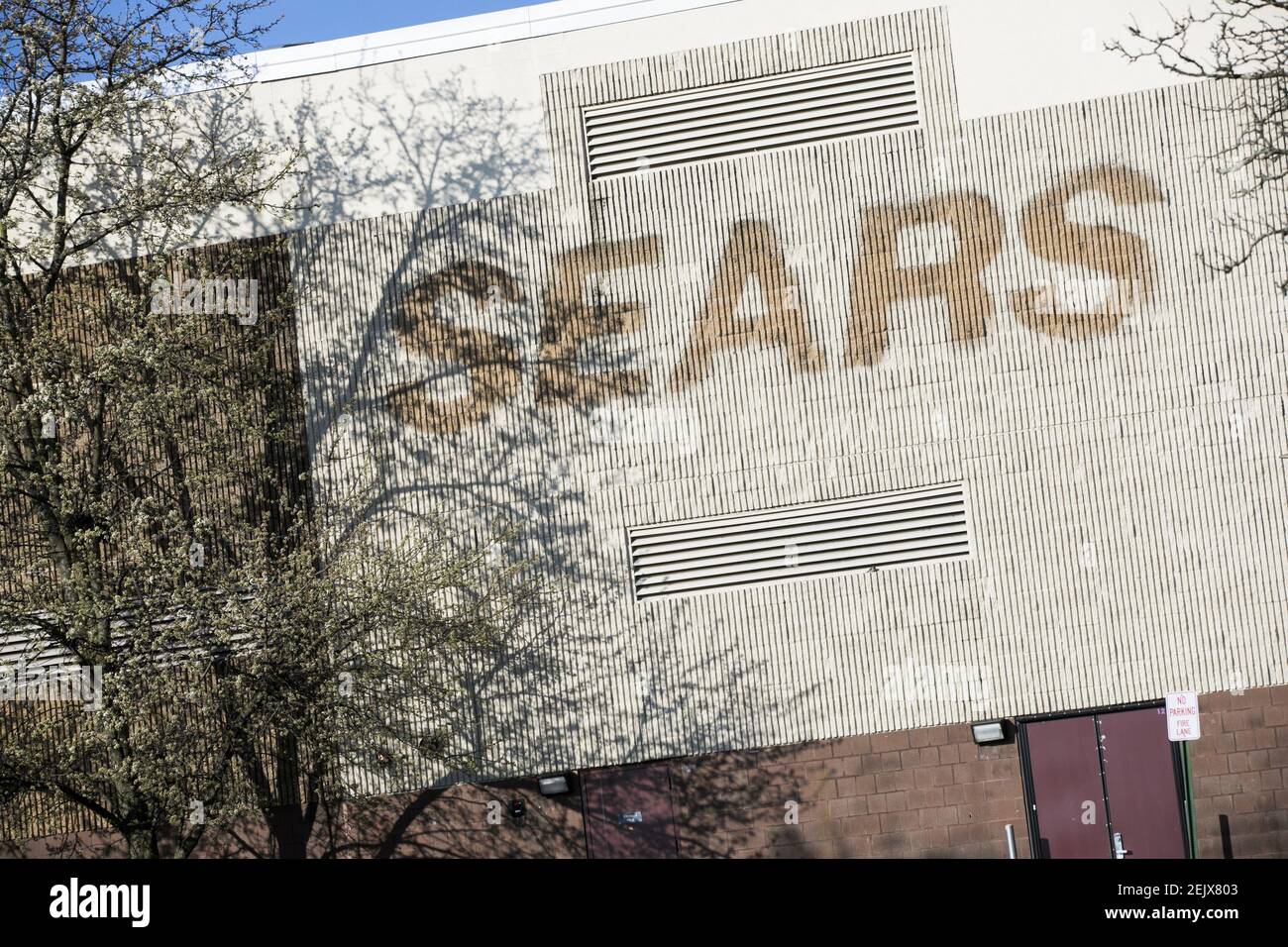 The faded outline of a Sears logo sign outside of a closed and ...
