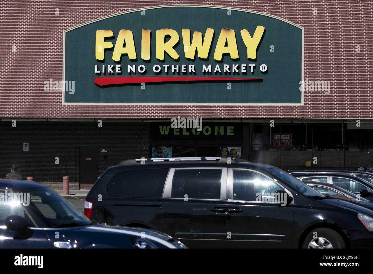 A logo sign outside of a Fairway Market retail grocery store location ...