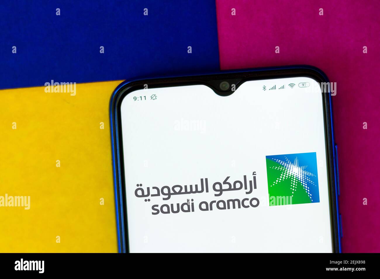 In this photo illustration a Saudi Aramco logo seen displayed on a ...