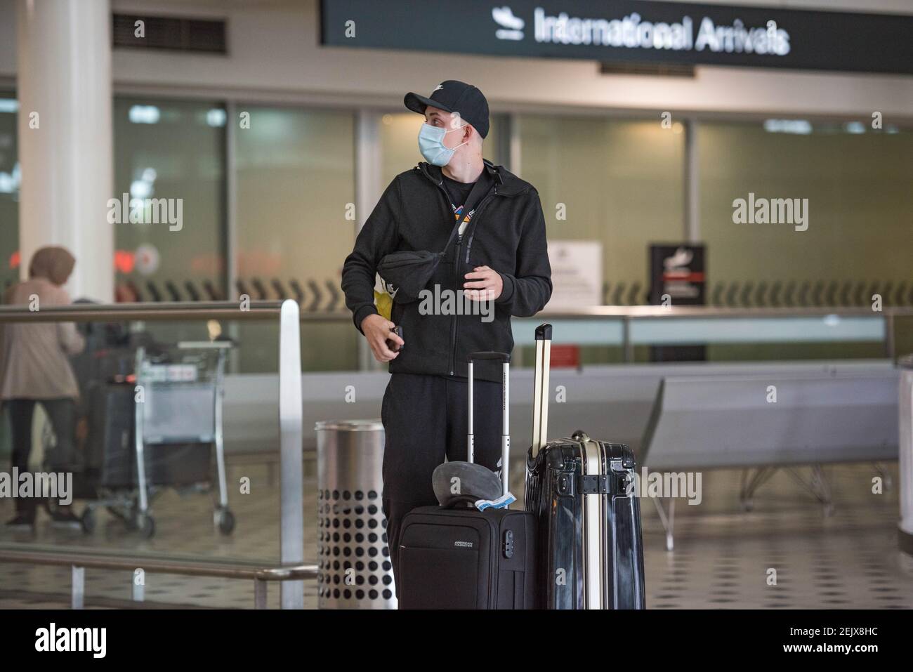 A man wears a face mask as a precaution against the spread of ...