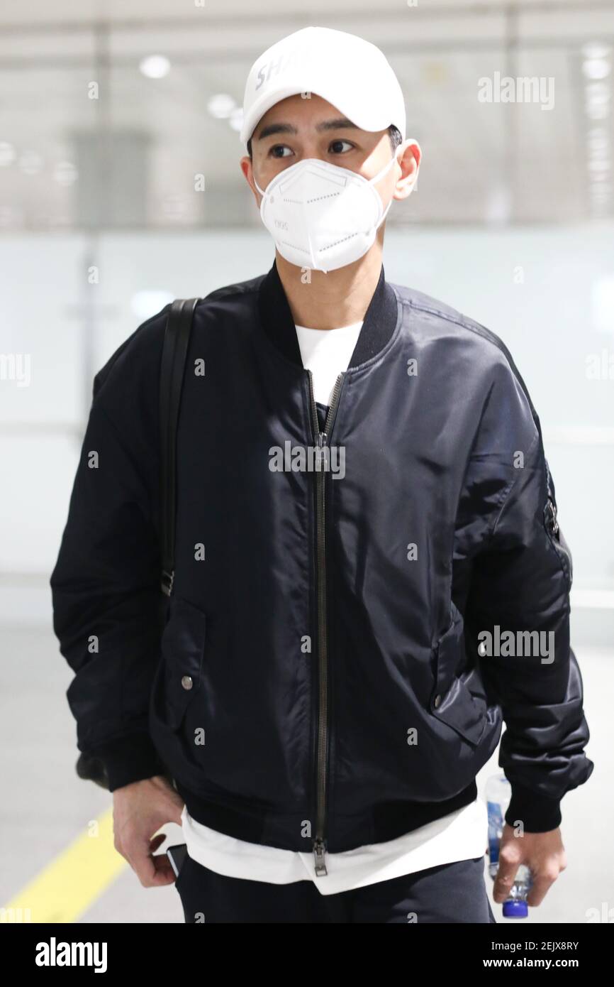 Chinese actor Qiao Zhenyu arrives at a Beijing airport after landing in Beijing, China, 24 March ...