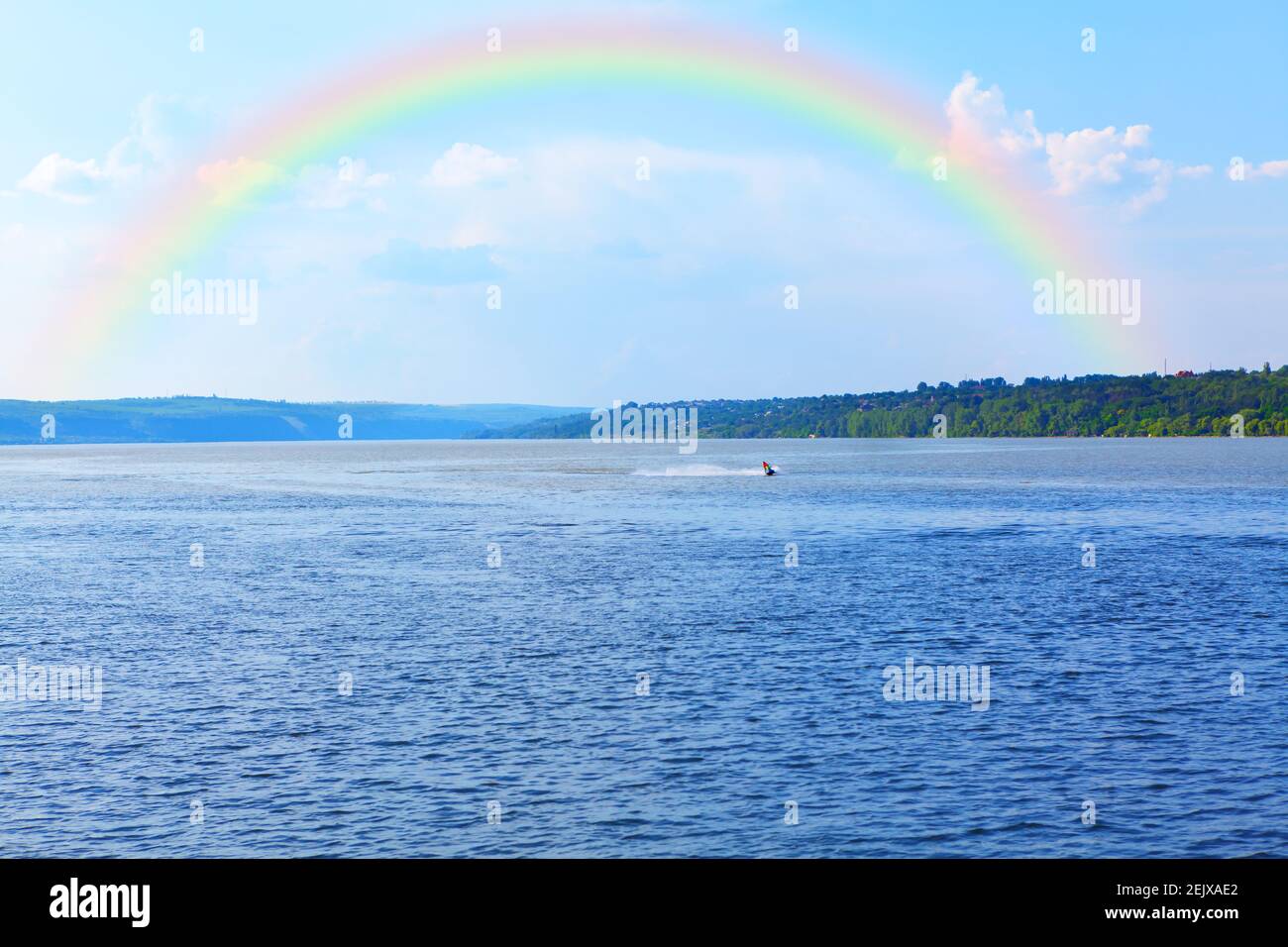 Rainbow over the lake . Spectacular natural phenomenon Stock Photo - Alamy